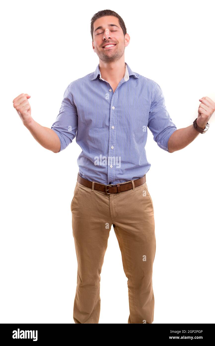 Happy young man celebrating with arms open Stock Photo - Alamy