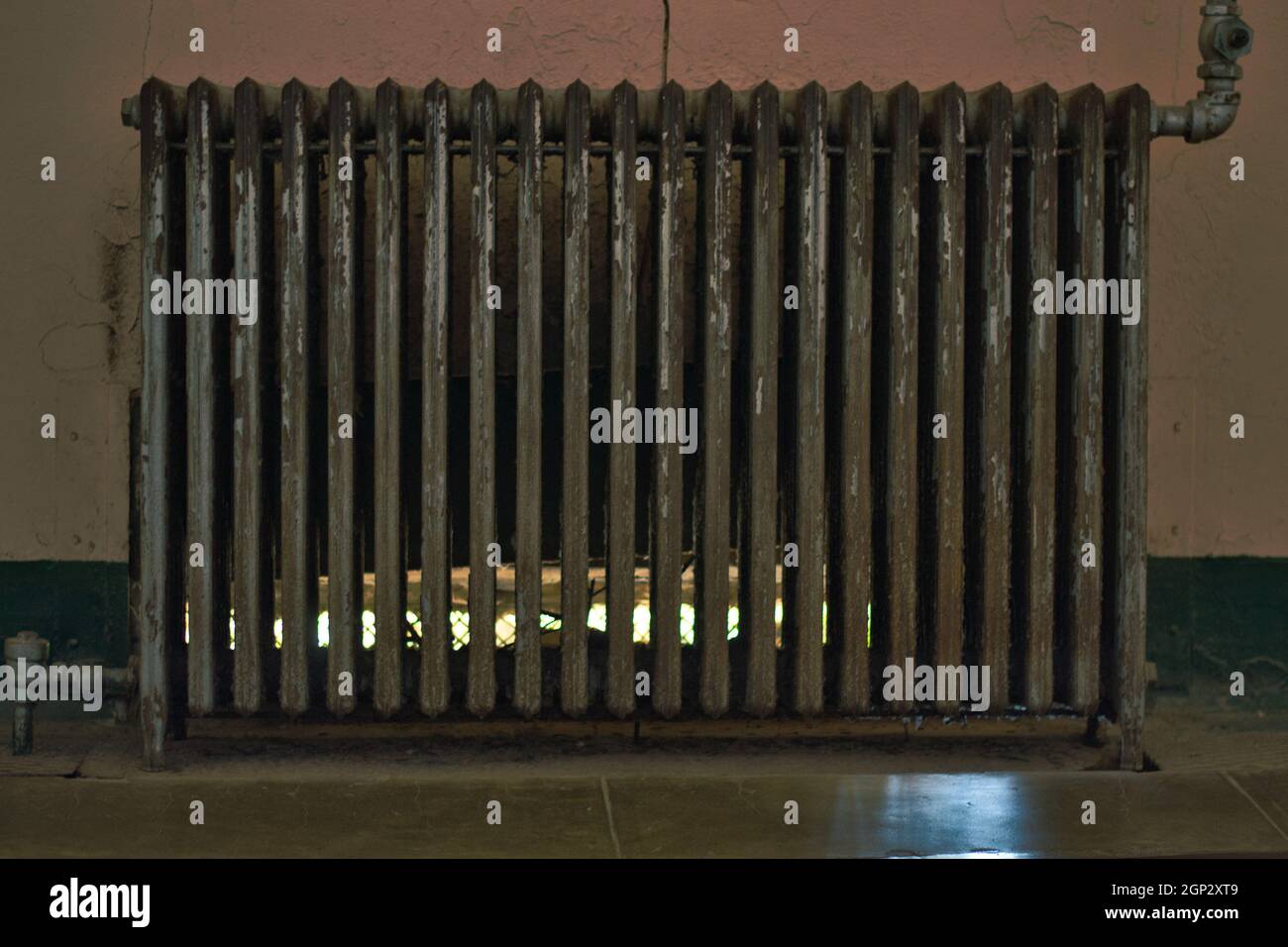 Vintage and retro or old-fashioned heating radiator against a wall ...