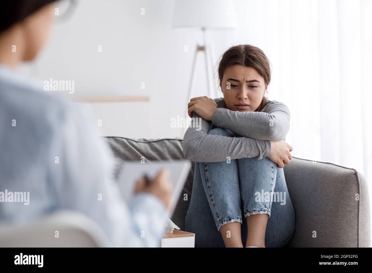 Confused european young lady suffering from depression, mental problems ...