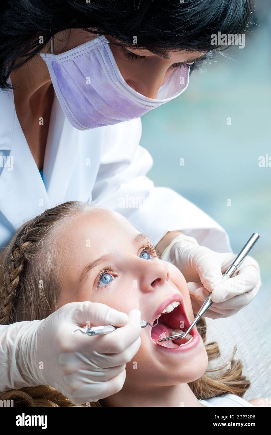 Close up portrait Female Dentist working on little girls teeth Stock ...