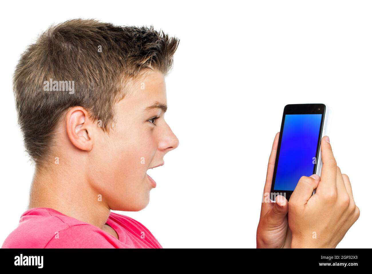 Portrait of Teen boy holding smart phone with surprised face expression ...