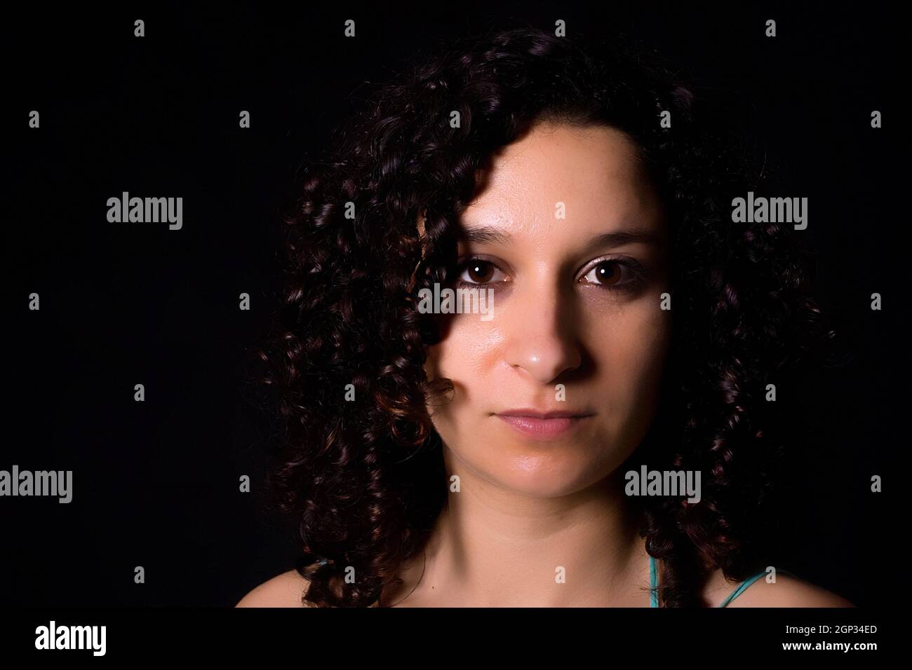 Young girl low key portrait - isolated on black Stock Photo - Alamy