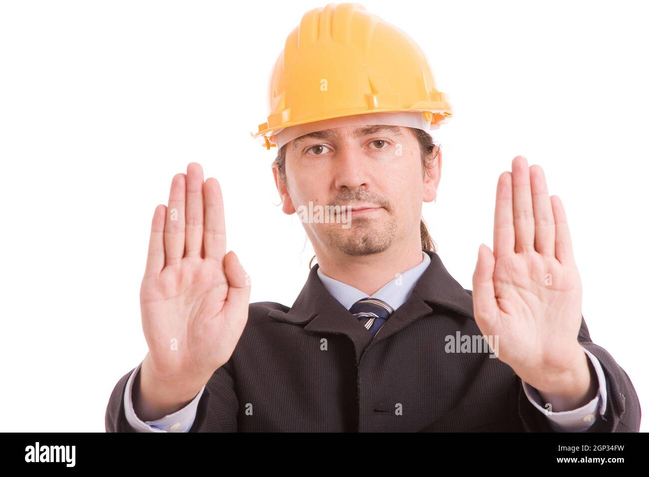 Engineer with yellow hat making stop sign Stock Photo - Alamy