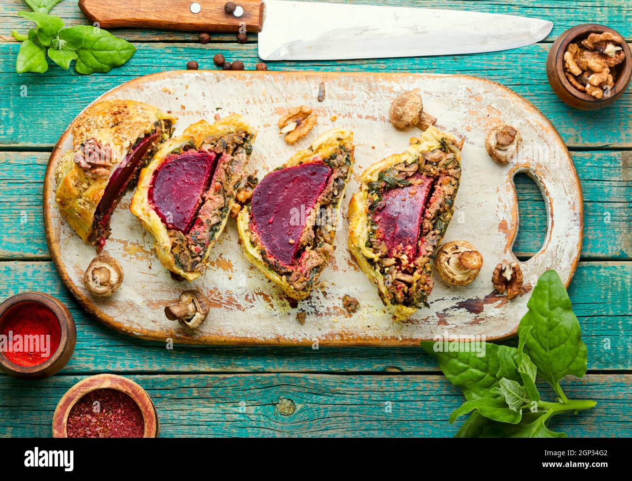 Delicious beetroot pie sliced on a kitchen board.Sliced pie Wellington ...