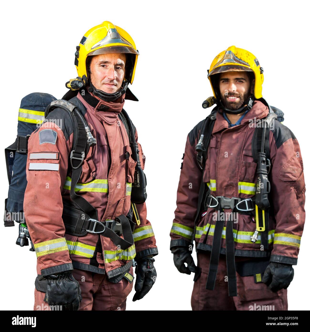 Two firemen wearing official fire fighting uniforms isolated on white ...