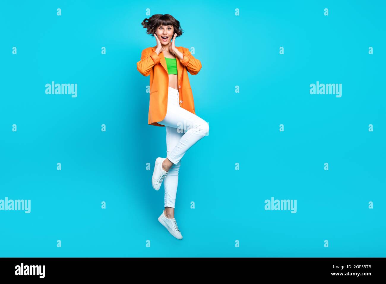 Full size photo of amazed shocked woman jump up air hand face active ...