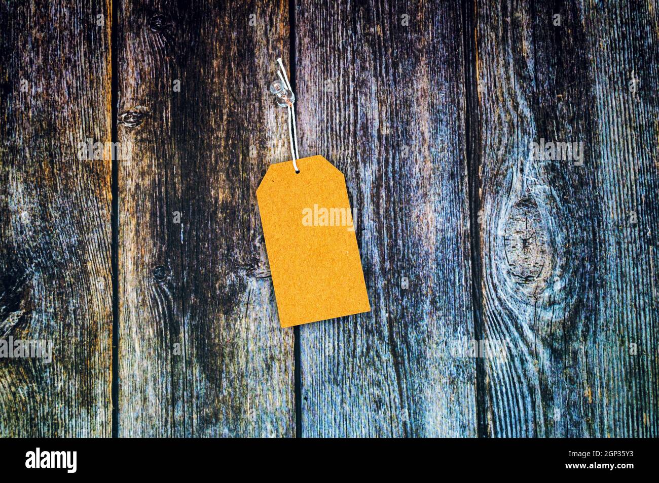 Blank gift label mockup with copy space pinned on a vintage wooden ...