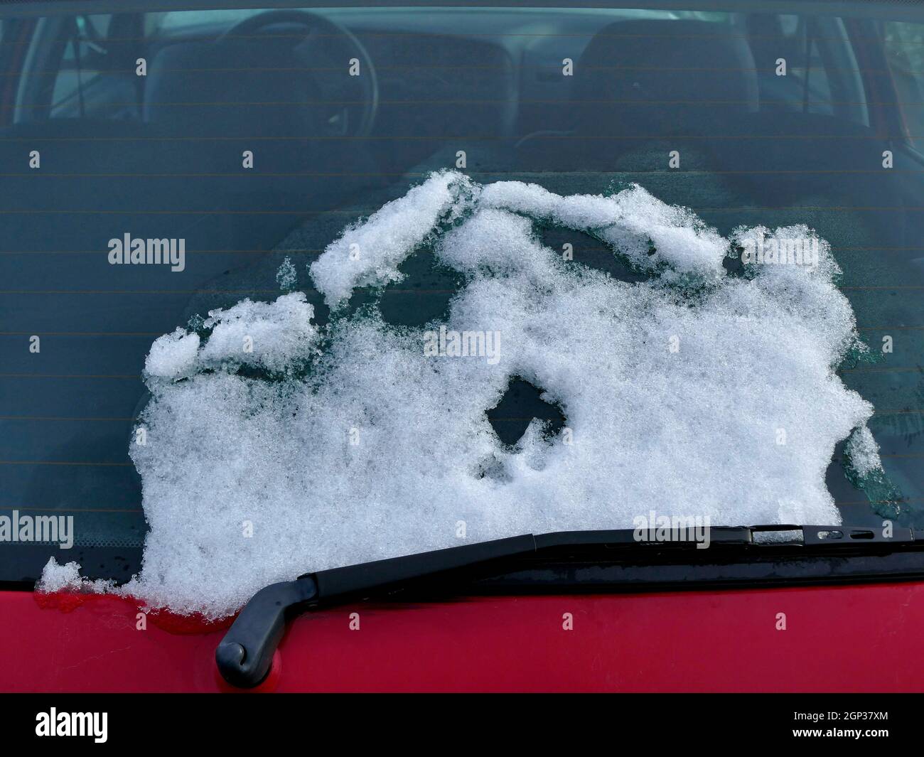 snow on a rear window of a red car Stock Photo - Alamy