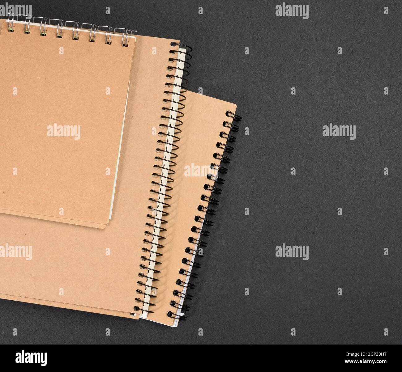 closed notepad with brown sheets on black background, close up Stock Photo - Alamy