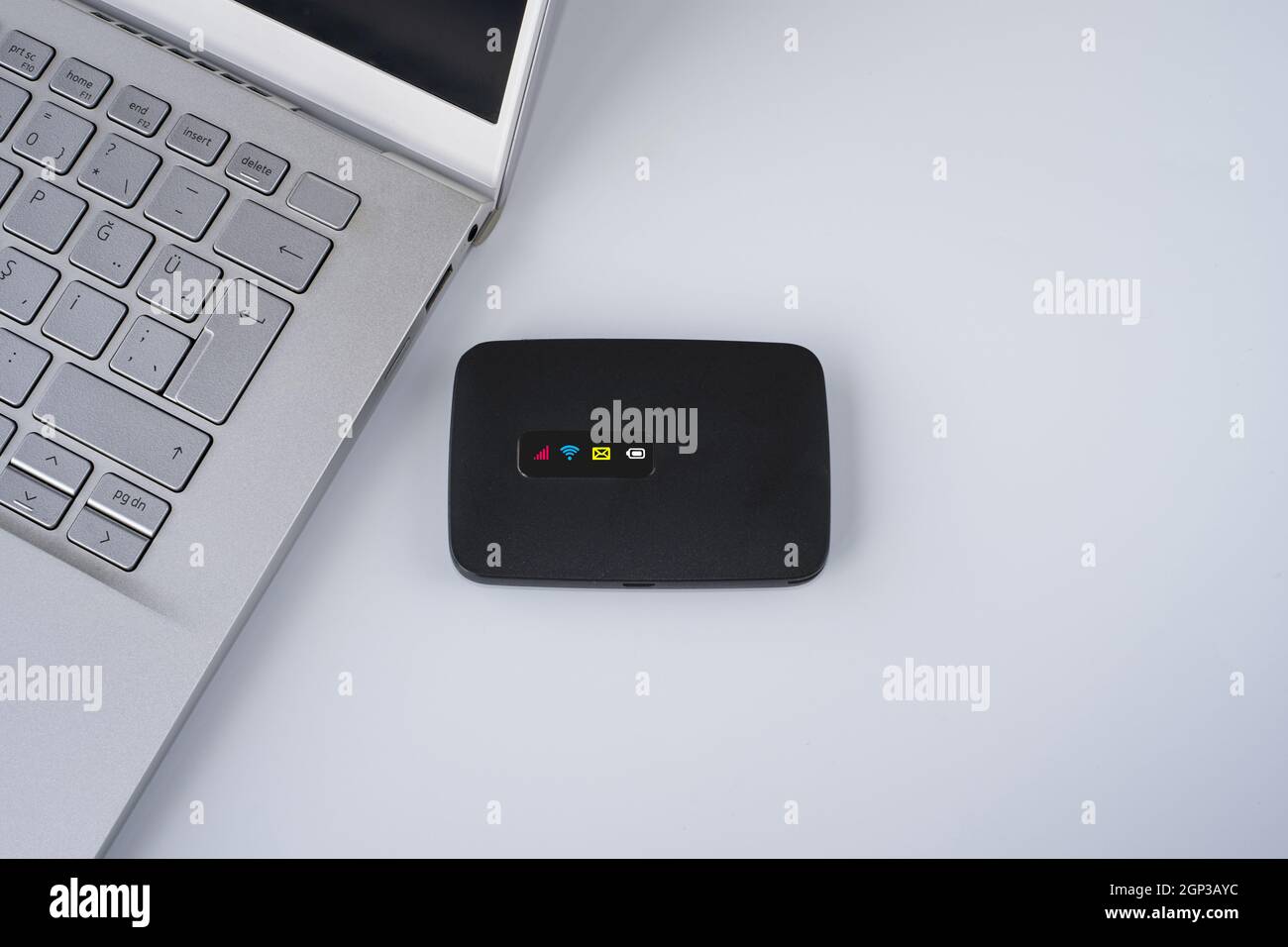 Mobile or pocket wifi device, near laptop or notebook on isolated white ...