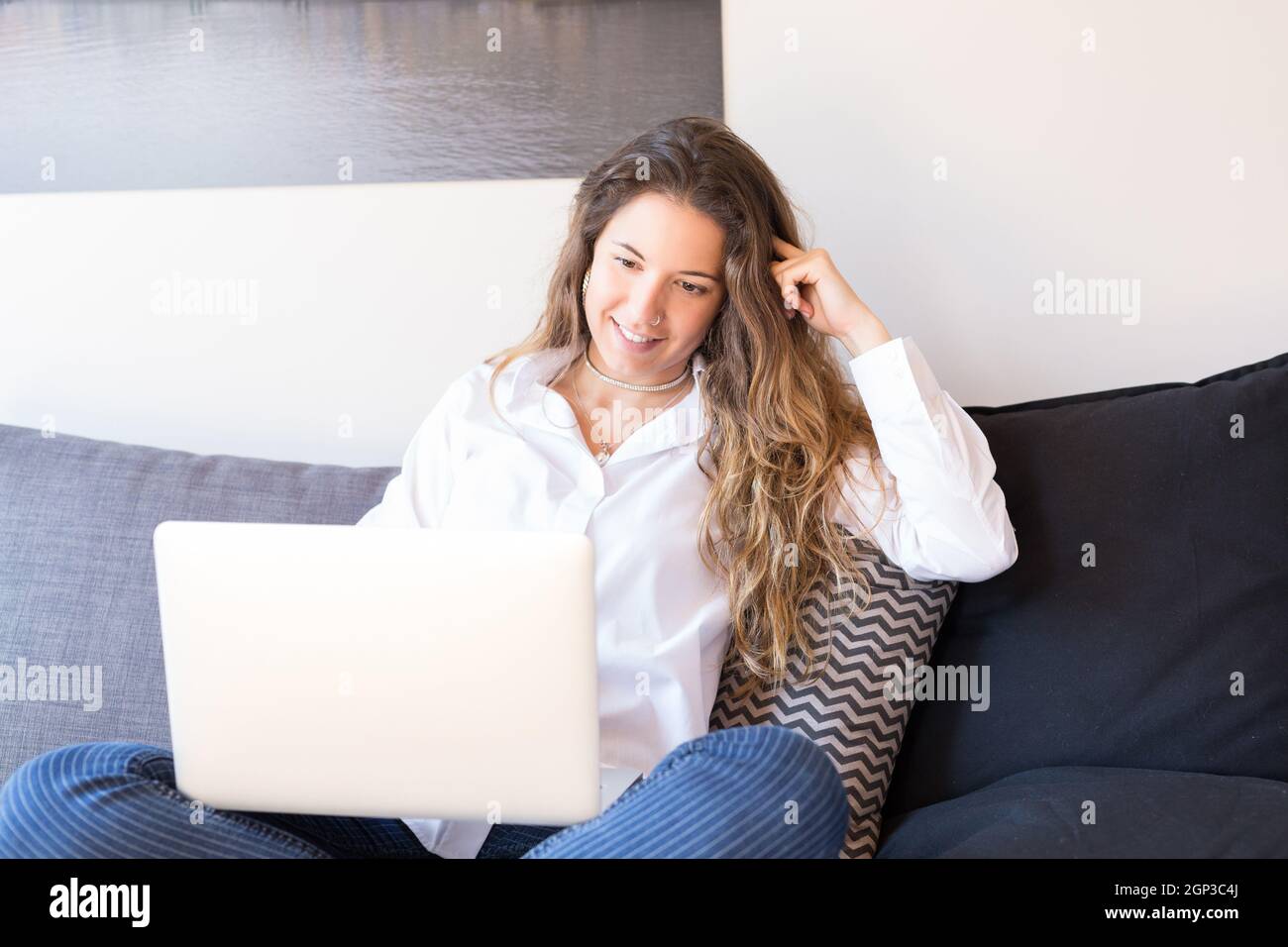 Beautiful woman relaxing with a computer Stock Photo - Alamy