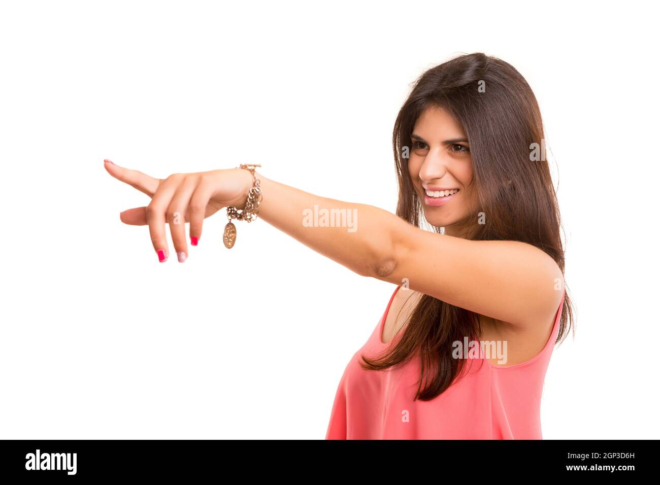 A beautiful woman pointing to something, isolated over a copy space ...