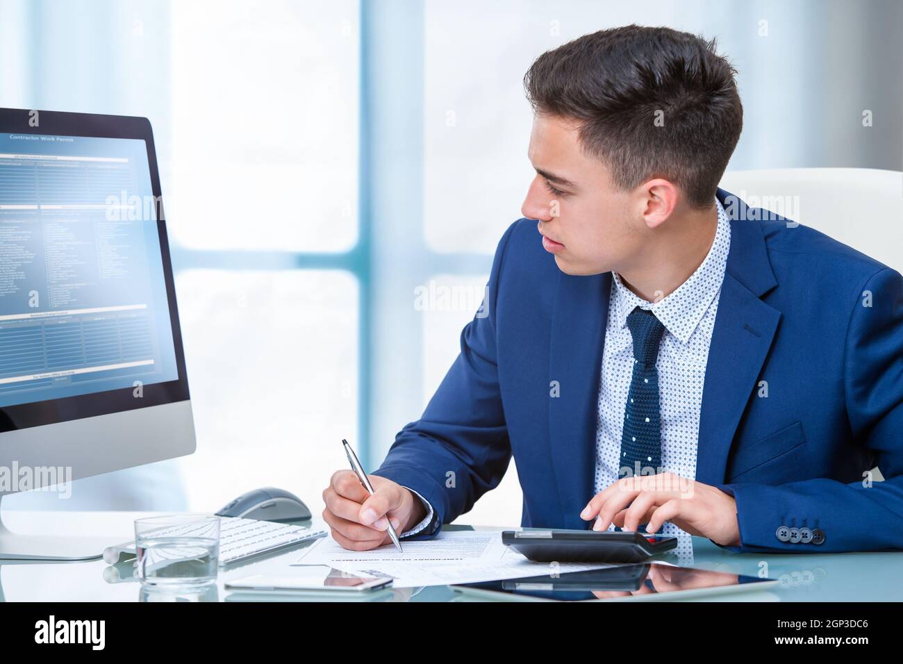 Close up portrait of young accountant doing on line internet ...