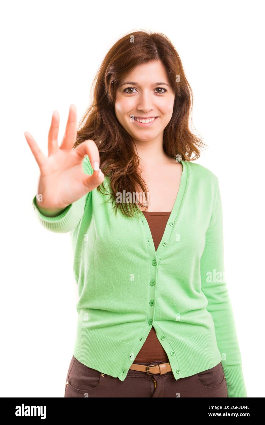 Beautiful young woman signaling ok, isolated over copy space background ...