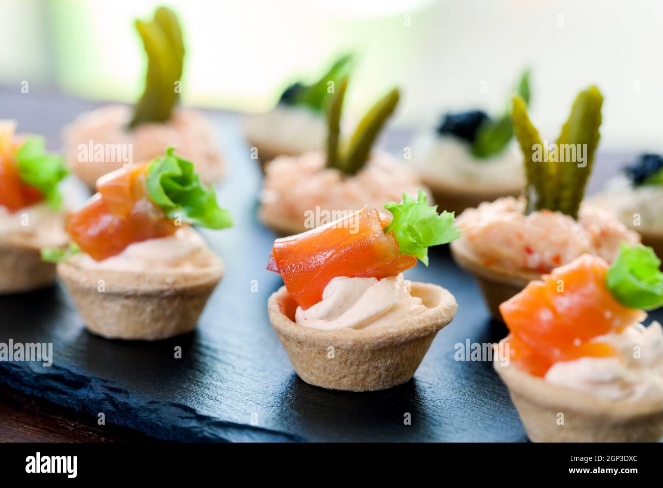 Macro close up of Mini puff pastry tartlets with smoked salmon,creamy ...