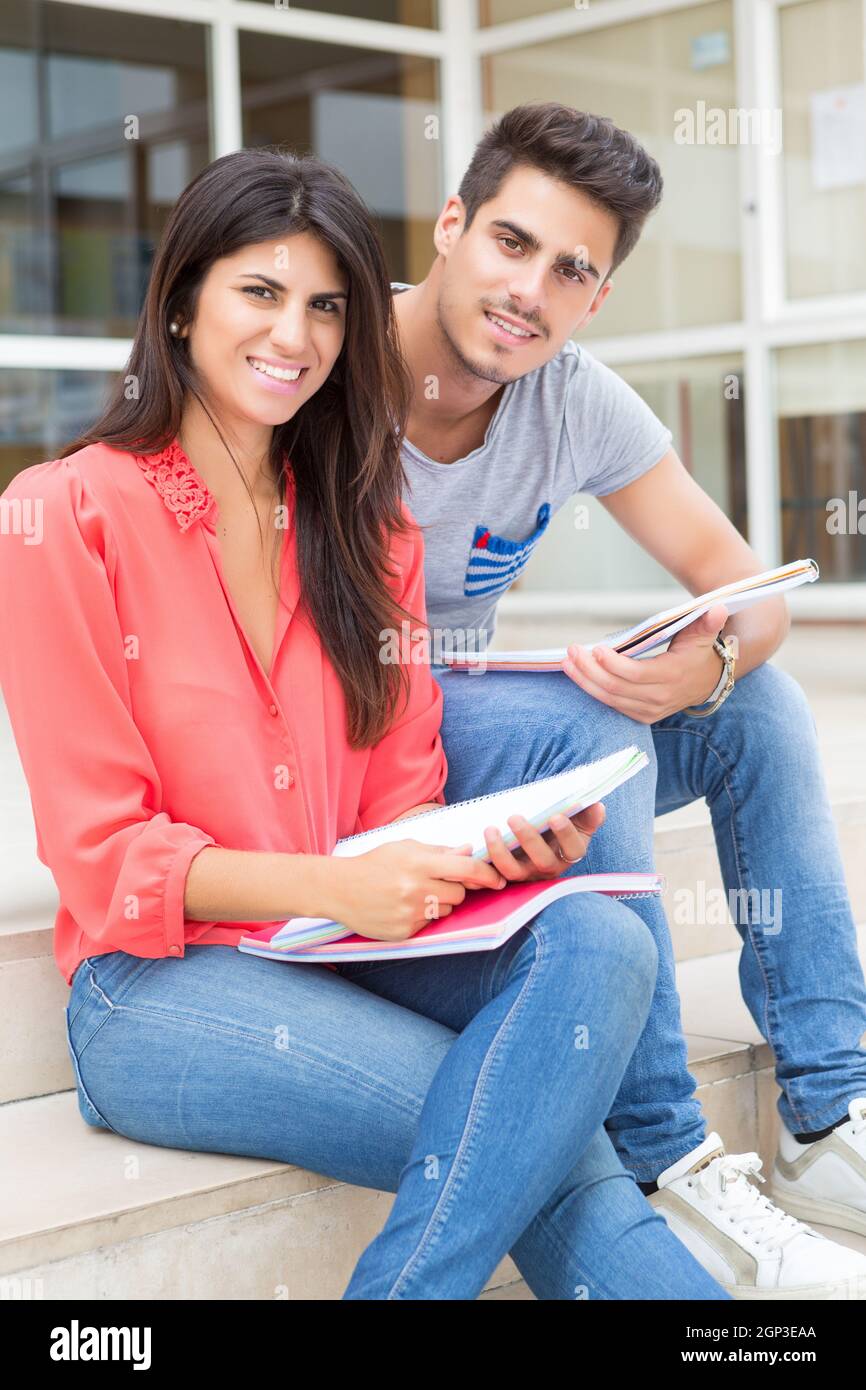 Couple of happy students at the university campus Stock Photo - Alamy