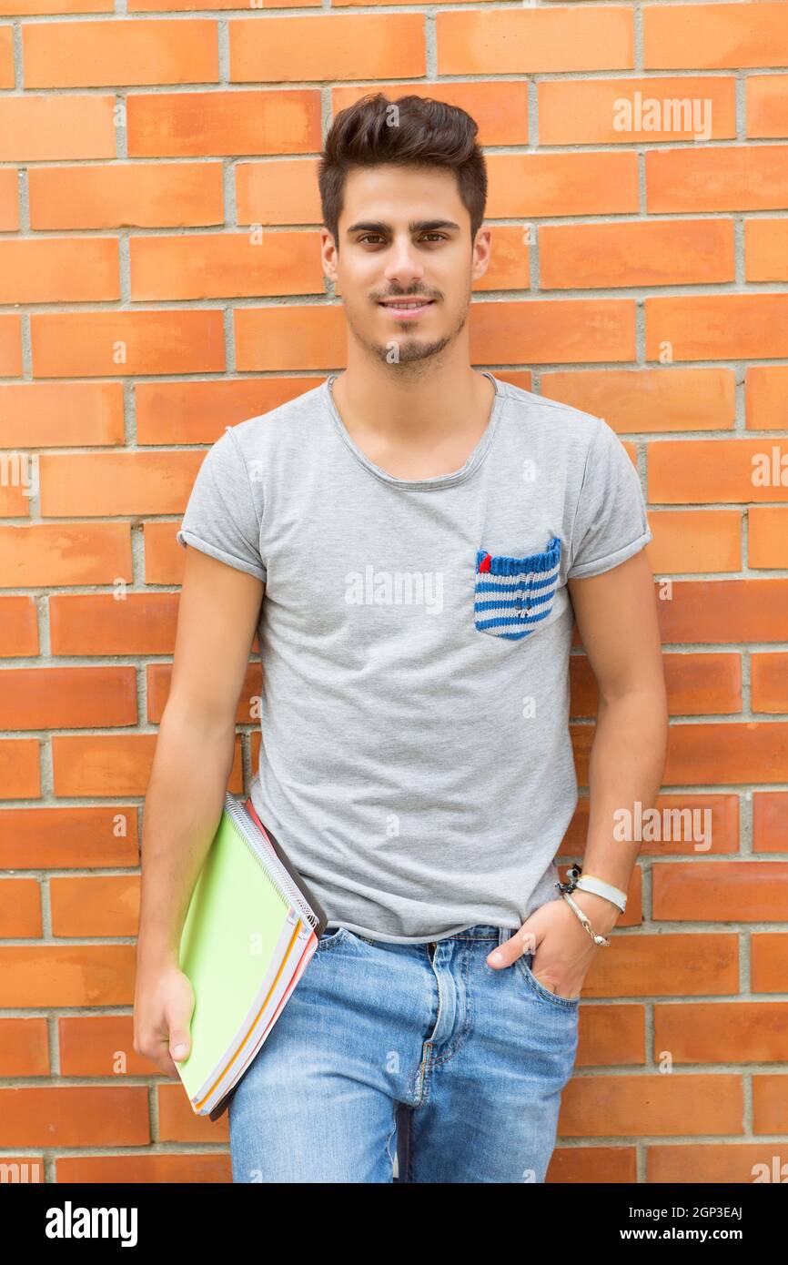 Happy student relaxing at the university campus Stock Photo - Alamy