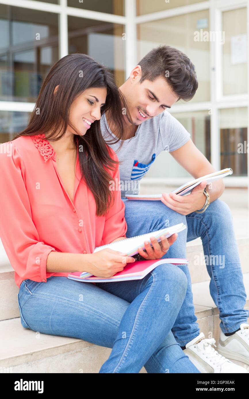 Couple of happy students at the university campus Stock Photo - Alamy