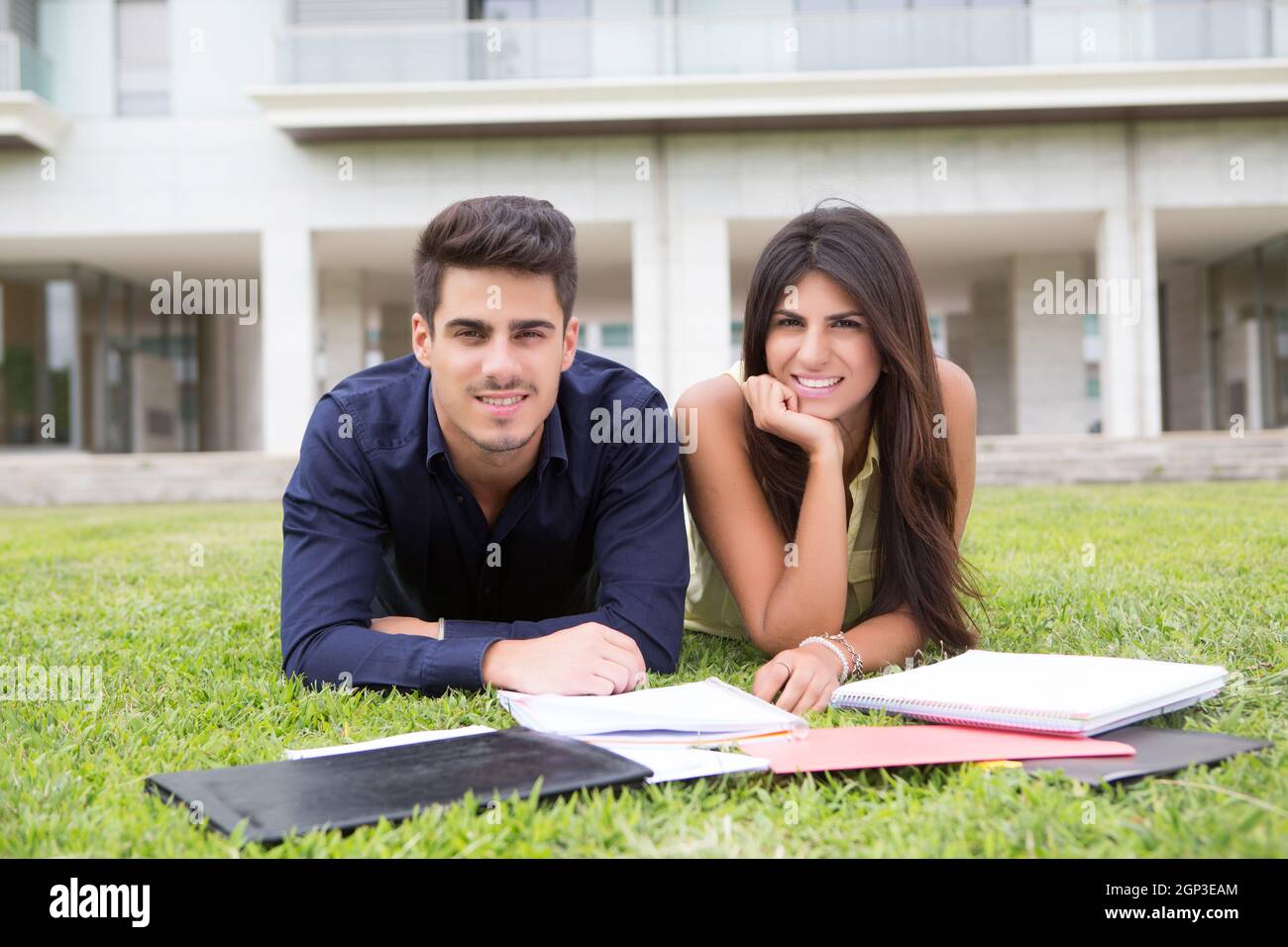 Couple of happy students at the university campus Stock Photo - Alamy