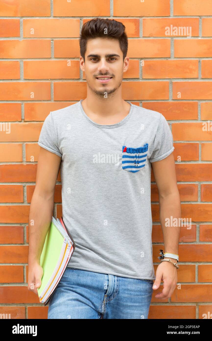 Happy student relaxing at the university campus Stock Photo - Alamy