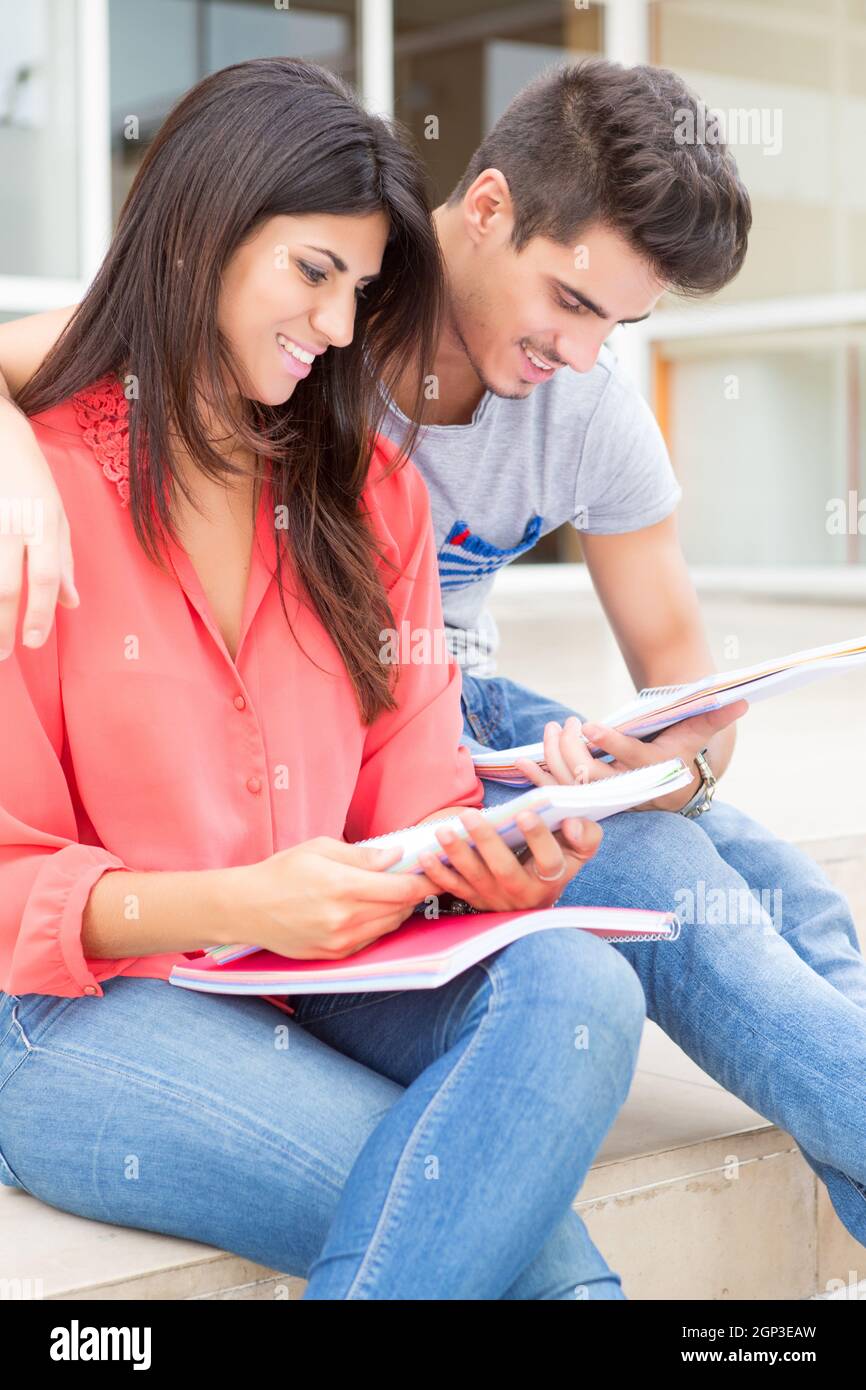 Couple of happy students at the university campus Stock Photo - Alamy