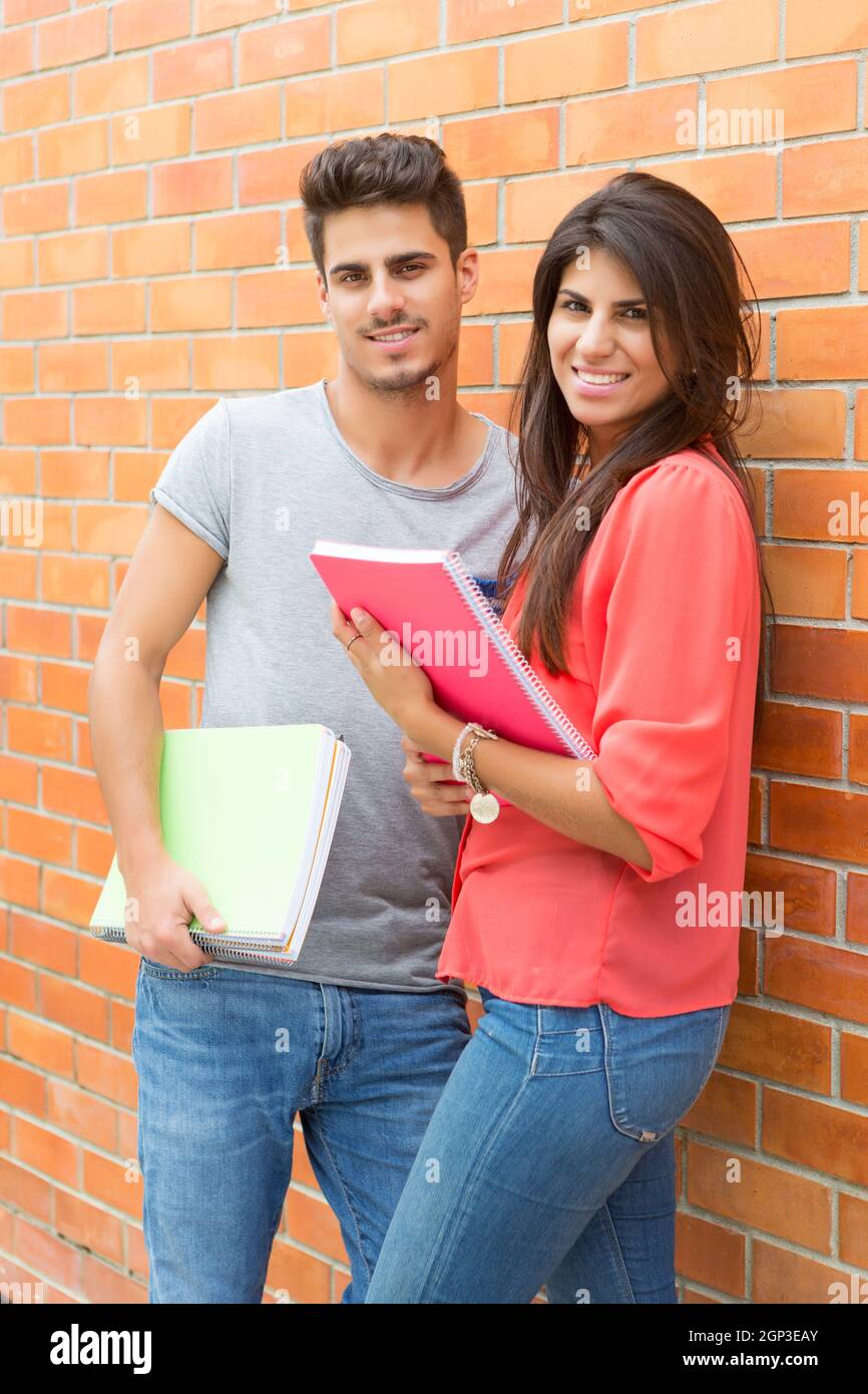 Couple of happy students at the university campus Stock Photo - Alamy
