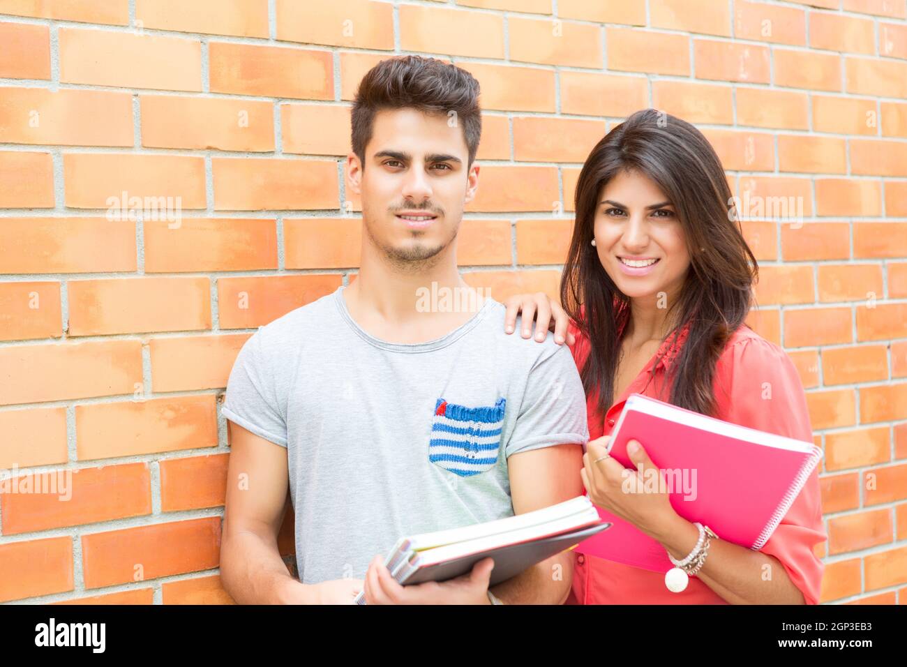 Couple of happy students at the university campus Stock Photo - Alamy