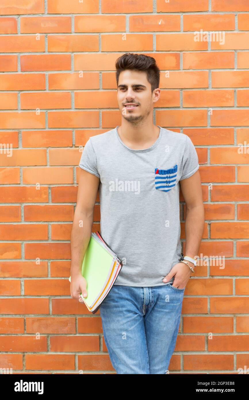 Happy student relaxing at the university campus Stock Photo - Alamy