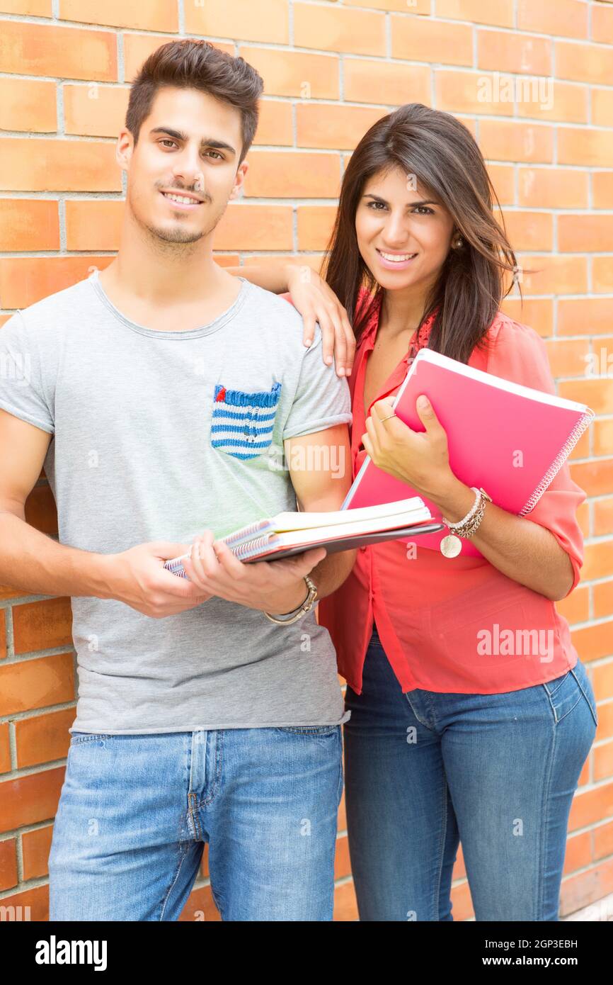 Couple of happy students at the university campus Stock Photo - Alamy