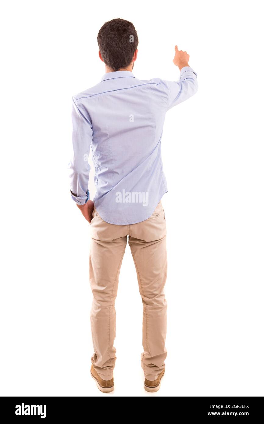 A young man with his back turned to camera, pointing to something Stock ...