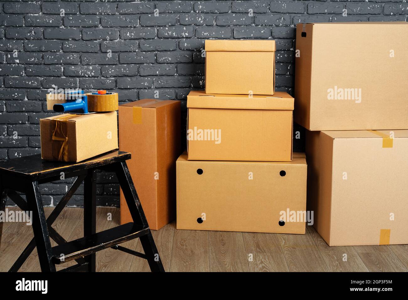 Moving in or moving out concept. Stack of boxes and packed furniture ...