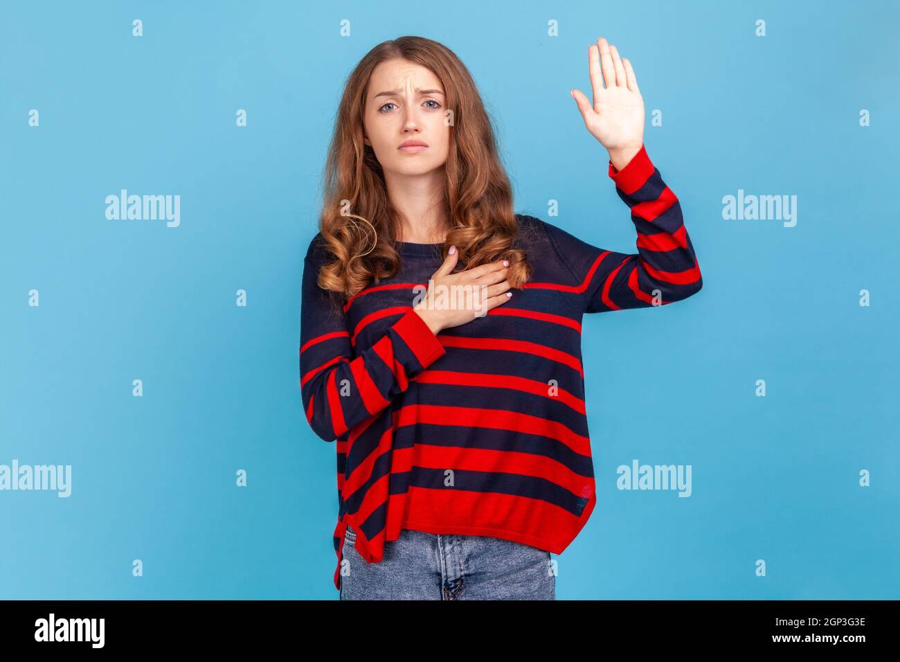 I promise. Portrait of beautiful woman wearing striped sweater, making ...