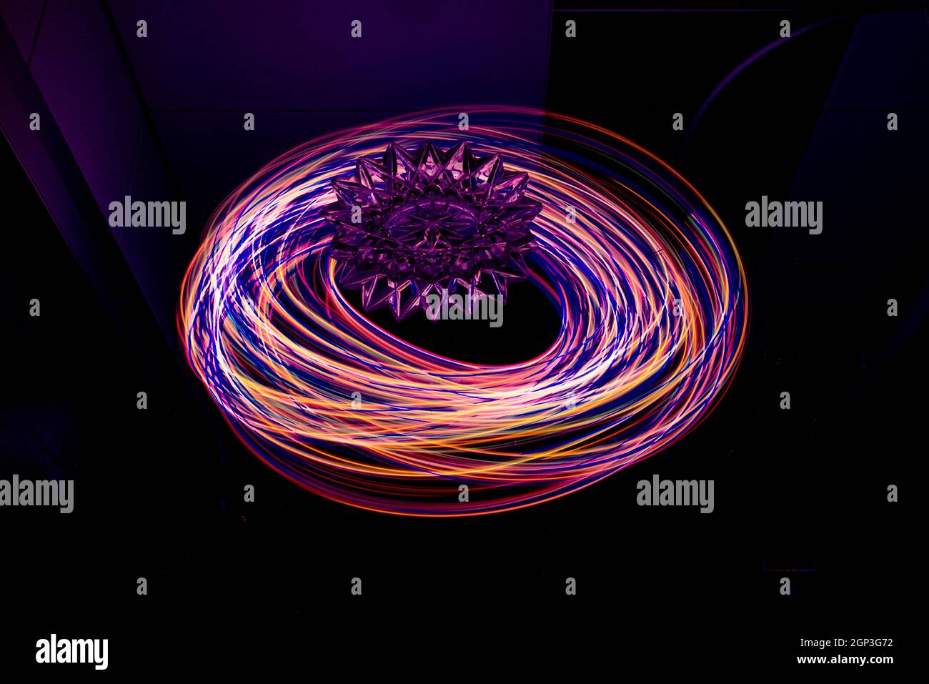 Painting with light on a mirror with small colored lamps and a glass ...