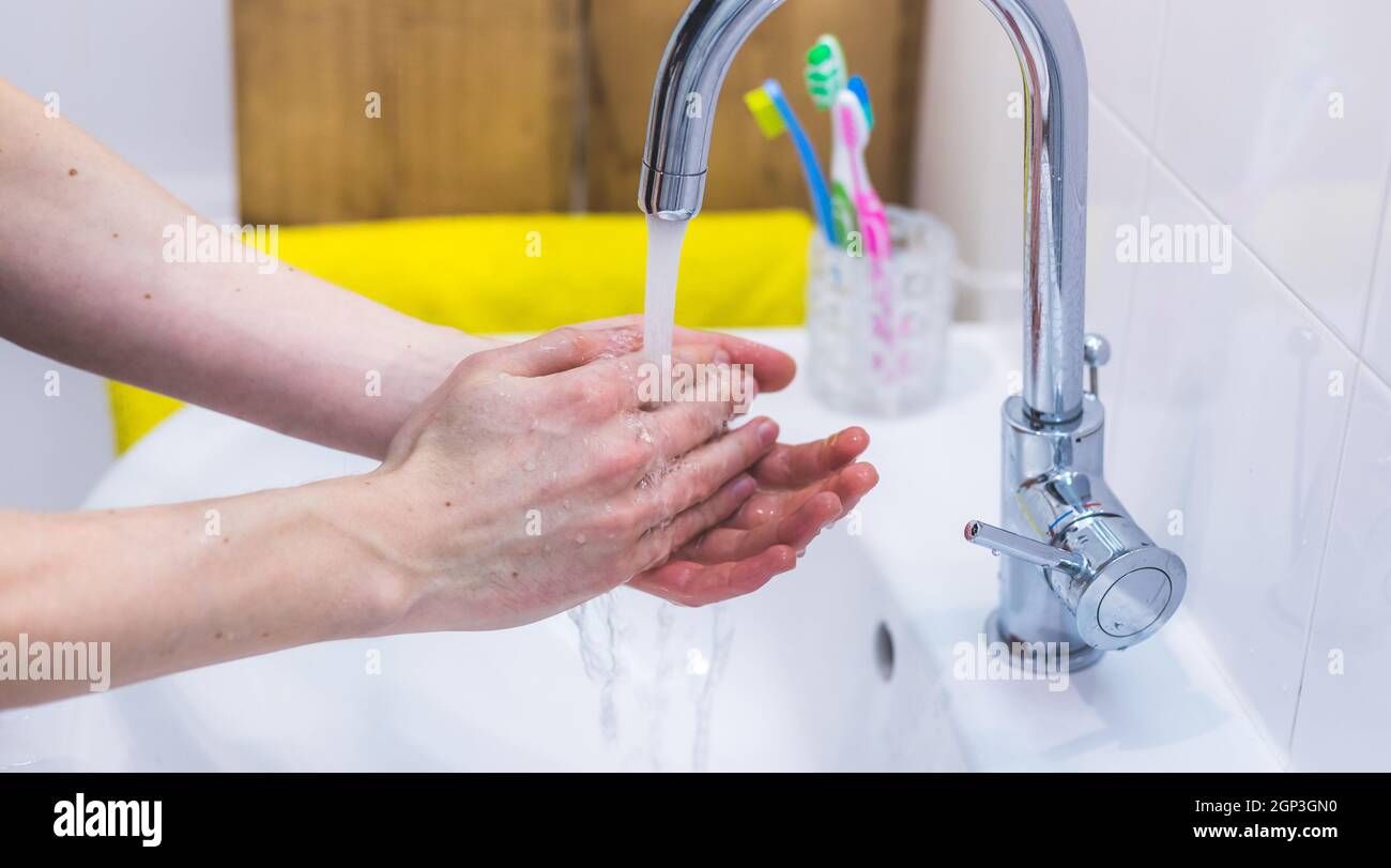 Close up washing hands in the bathroom. Prevention against flu or ...