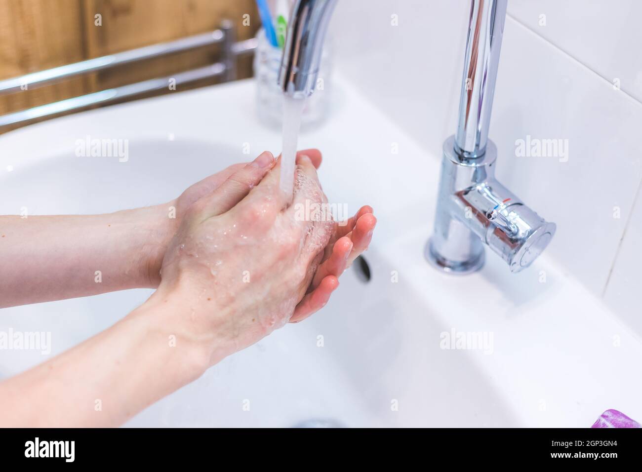 Close up washing hands in the bathroom. Prevention against flu or ...
