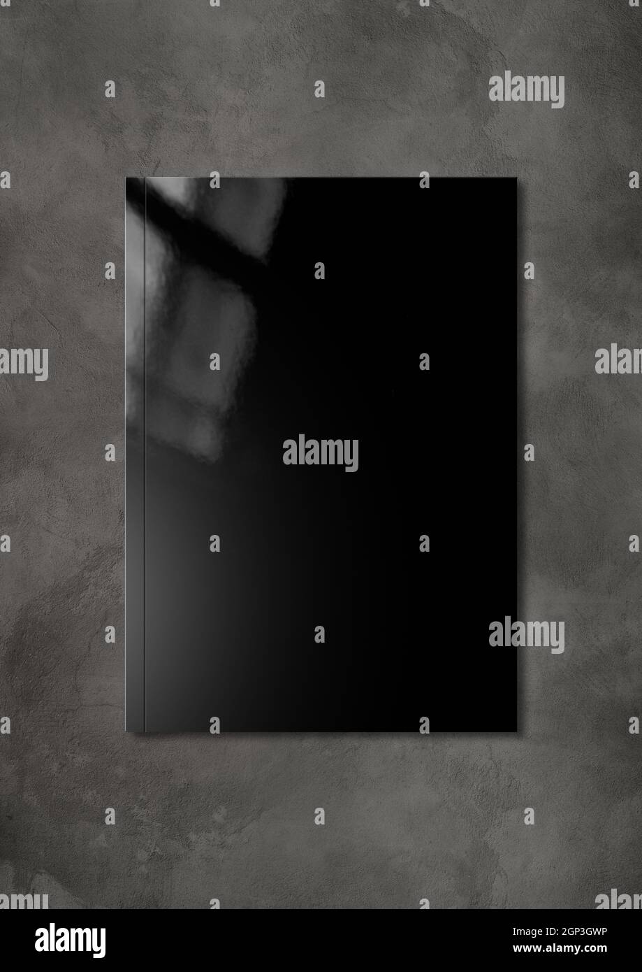 Black booklet cover isolated on dark concrete background, mockup ...