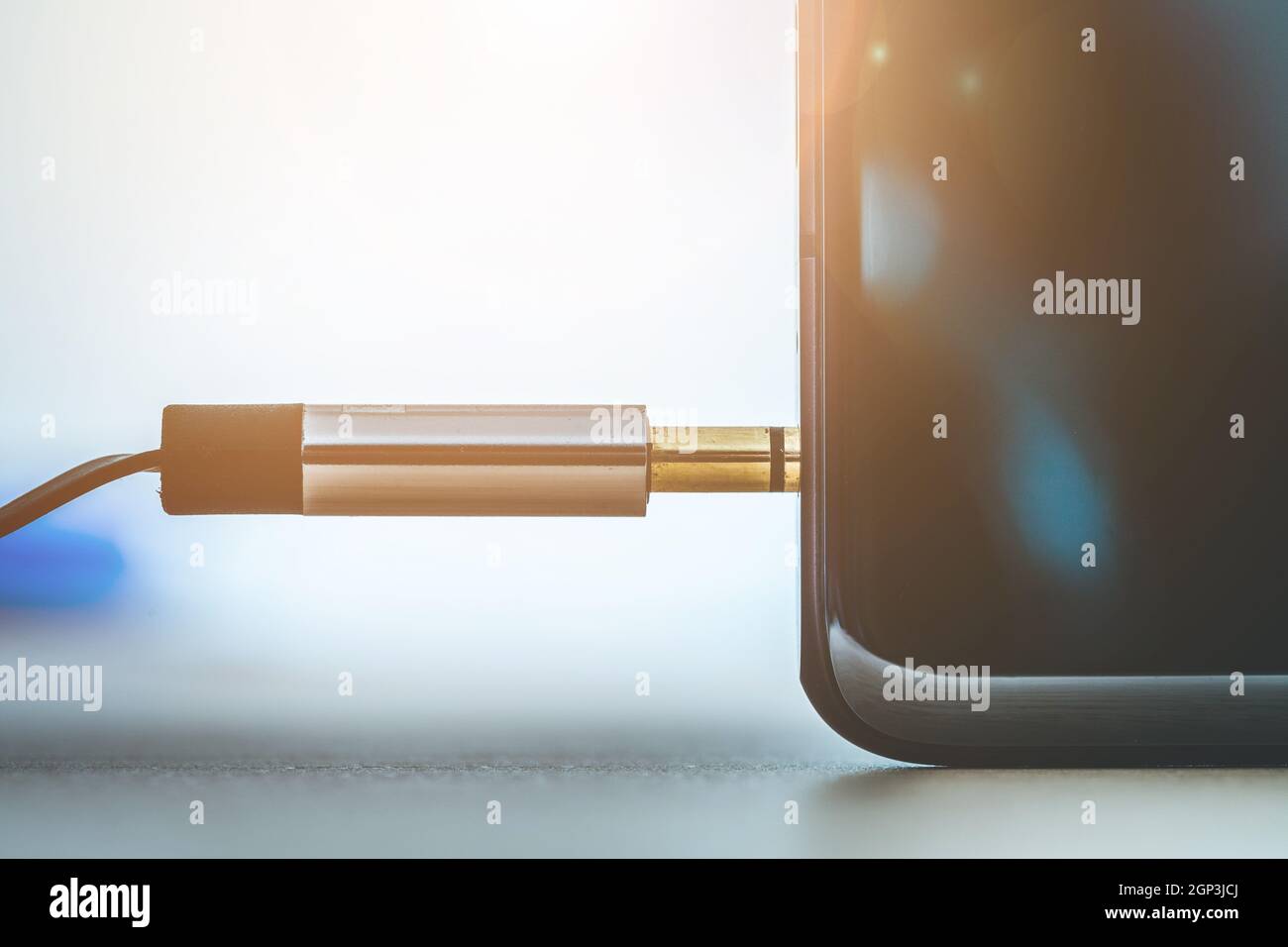Connection 3.5mm audio jack to a black mobile phone Stock Photo - Alamy
