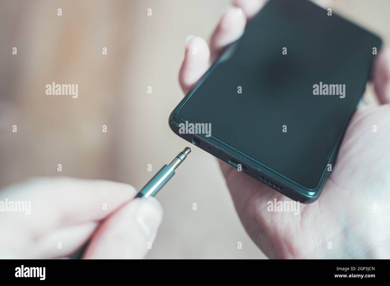 Connection 3.5mm audio jack to a black mobile phone Stock Photo - Alamy