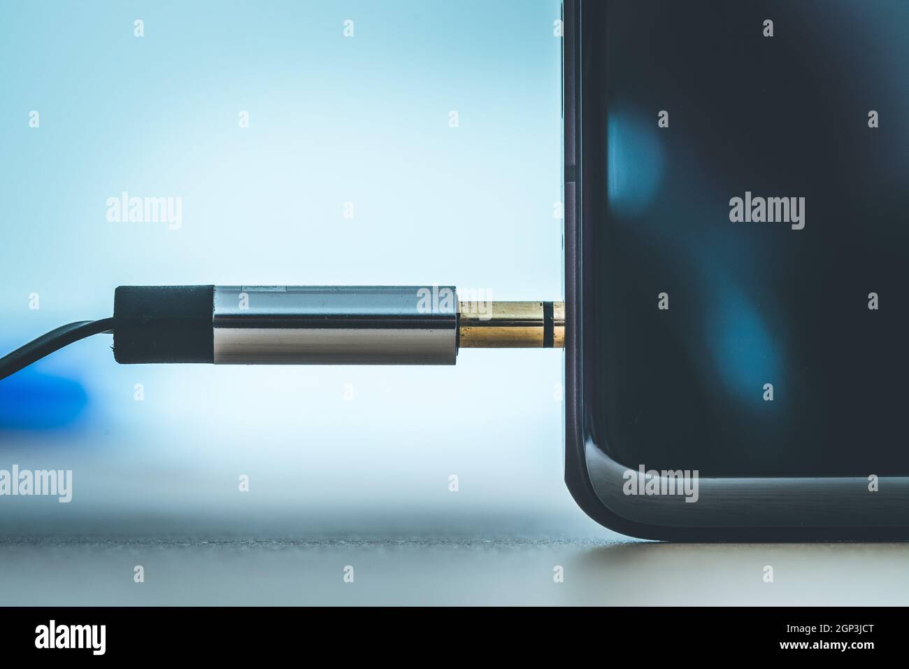 Connection 3.5mm audio jack to a black mobile phone Stock Photo - Alamy