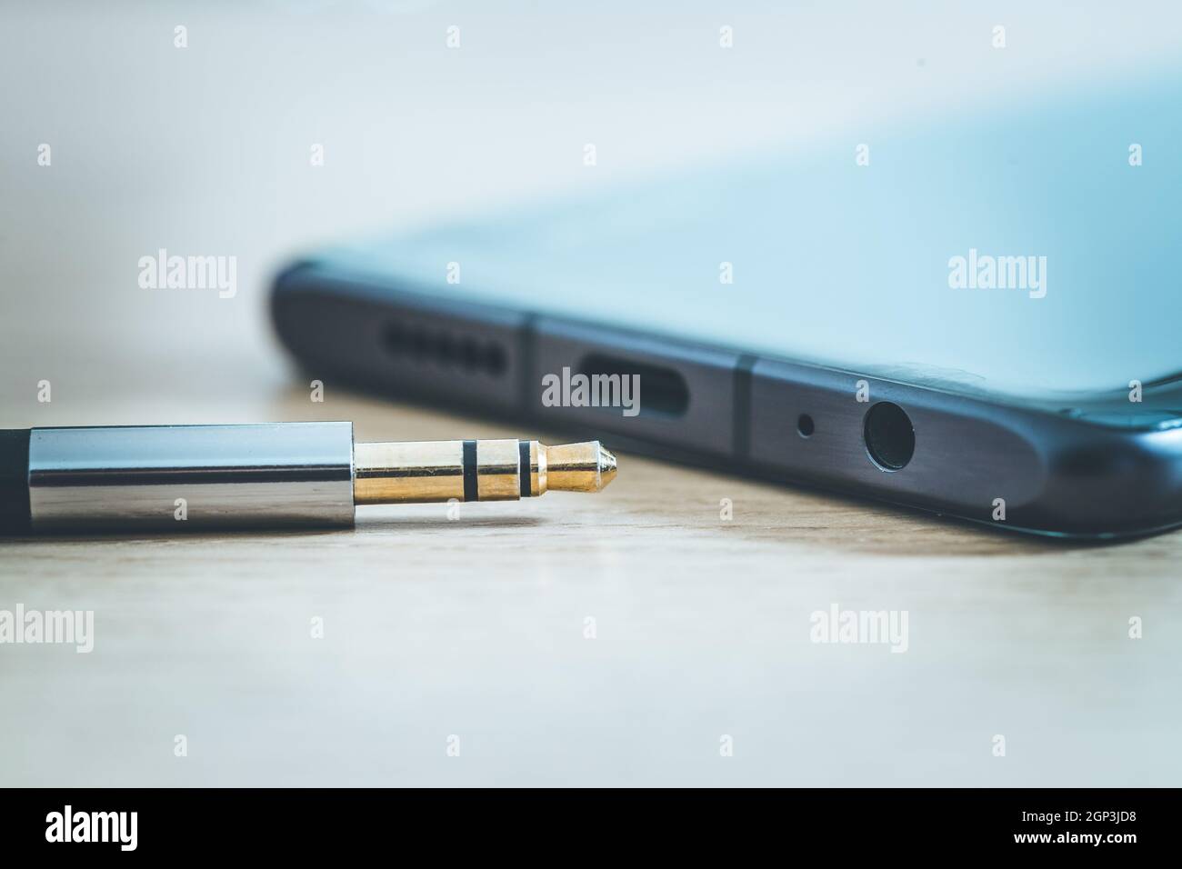Connection 3.5mm audio jack to a black mobile phone Stock Photo - Alamy