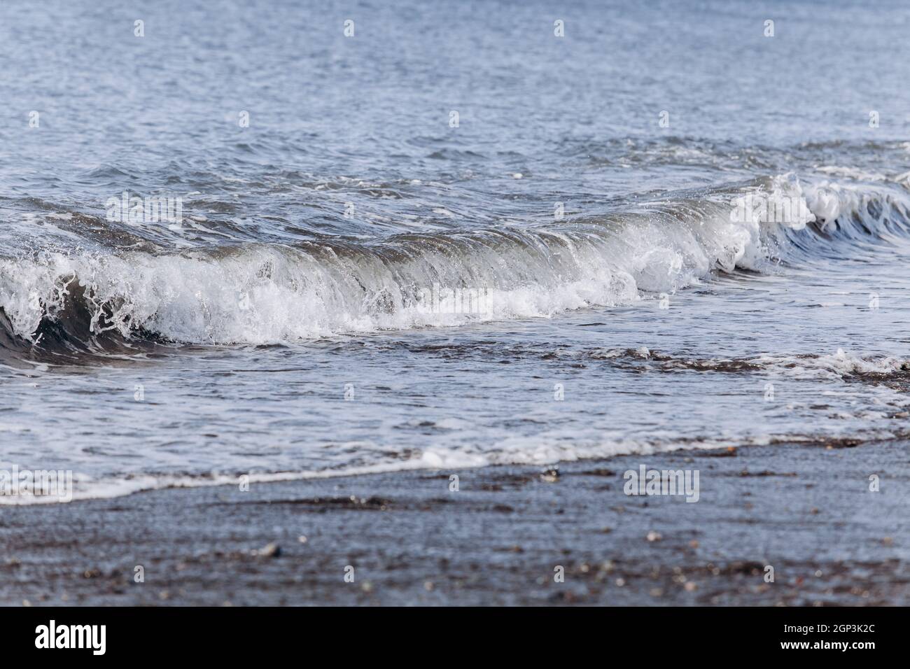Waves on the beach. A surge of water ashore Stock Photo - Alamy