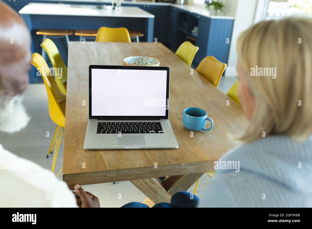Diverse couple sitting kitchen table hi-res stock photography and ...