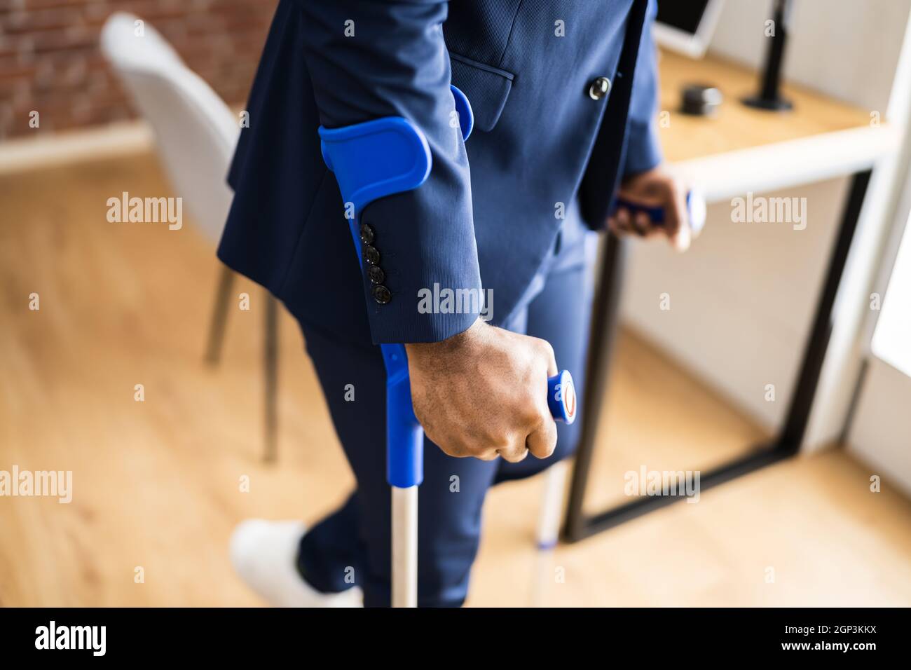 African Man Using Crutches For Recovery After Leg Fracture Stock Photo ...