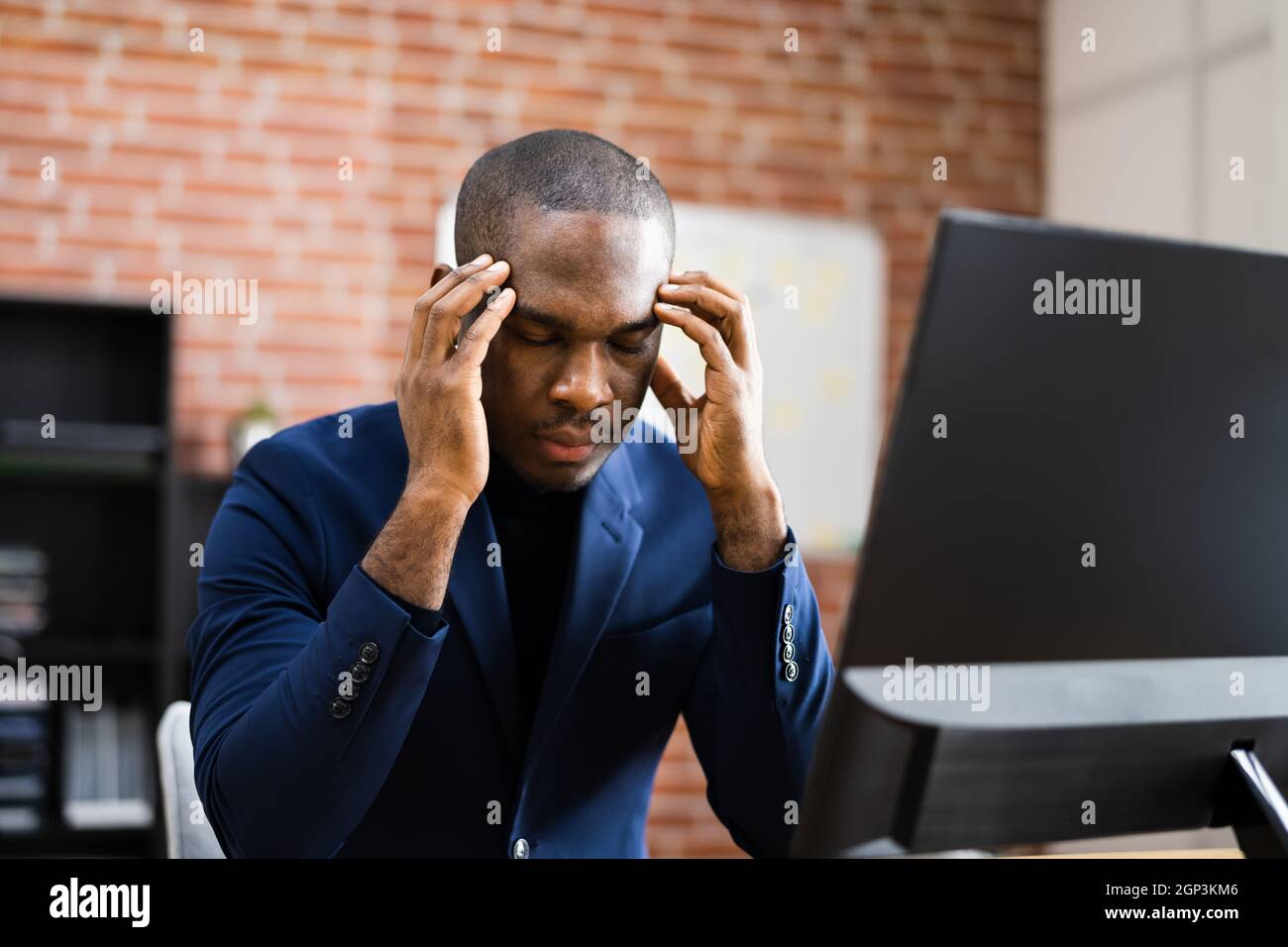 Distressed Man With Hangover At Work Having Headache Stock Photo - Alamy