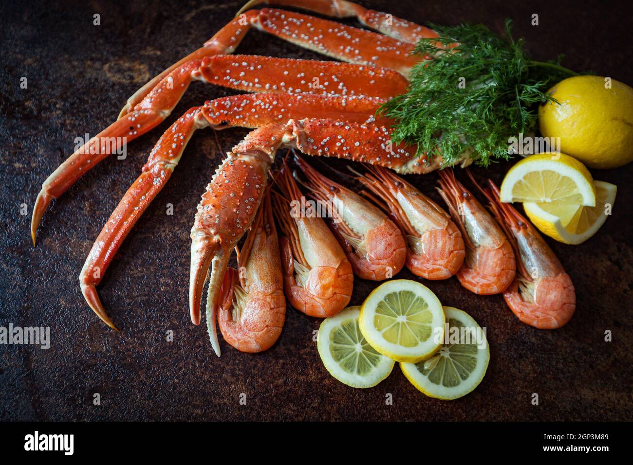 Crab legs on brown rustic background Stock Photo - Alamy
