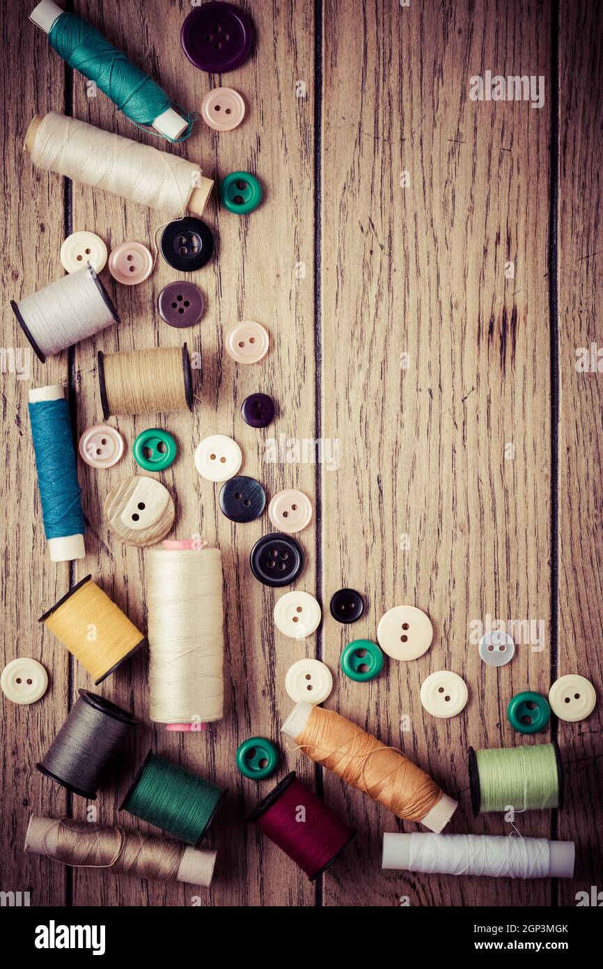 Sewing and craft tools - threads and buttons on wooden background in ...