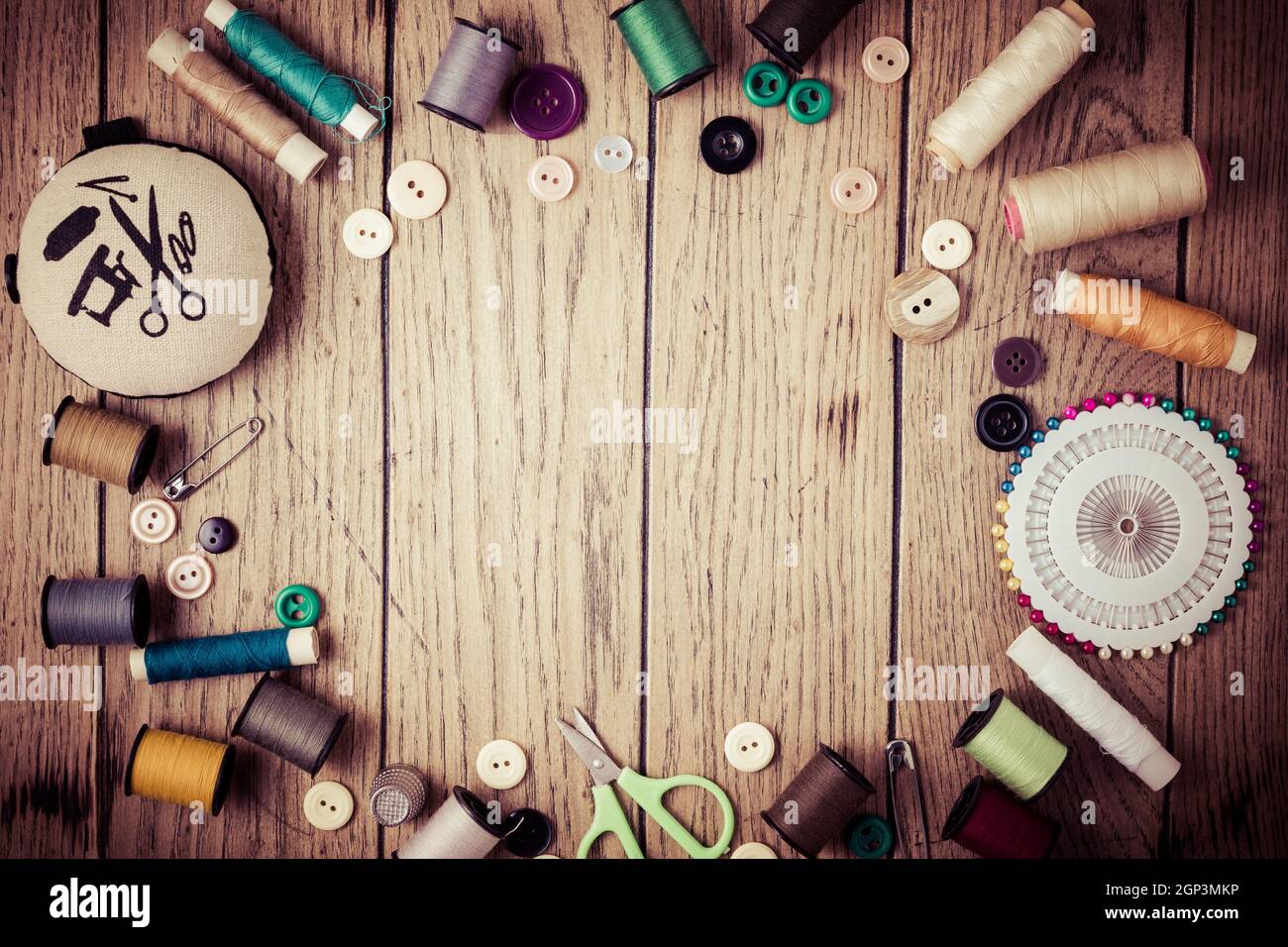 Sewing and craft tools - threads and buttons on wooden background in ...