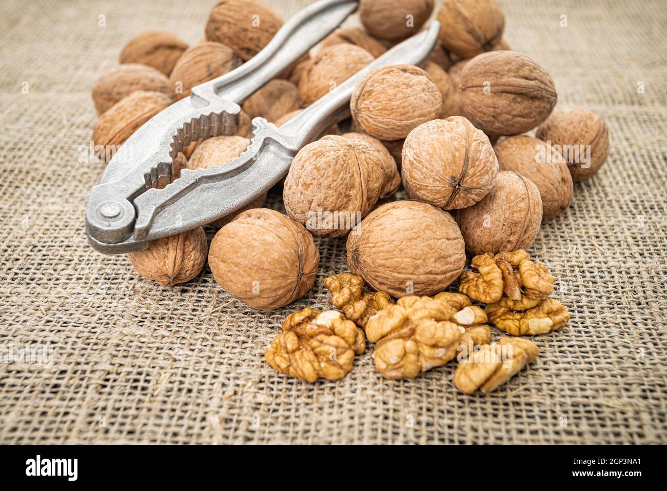 Walnut kernel background. Nutcracker with walnut Stock Photo - Alamy