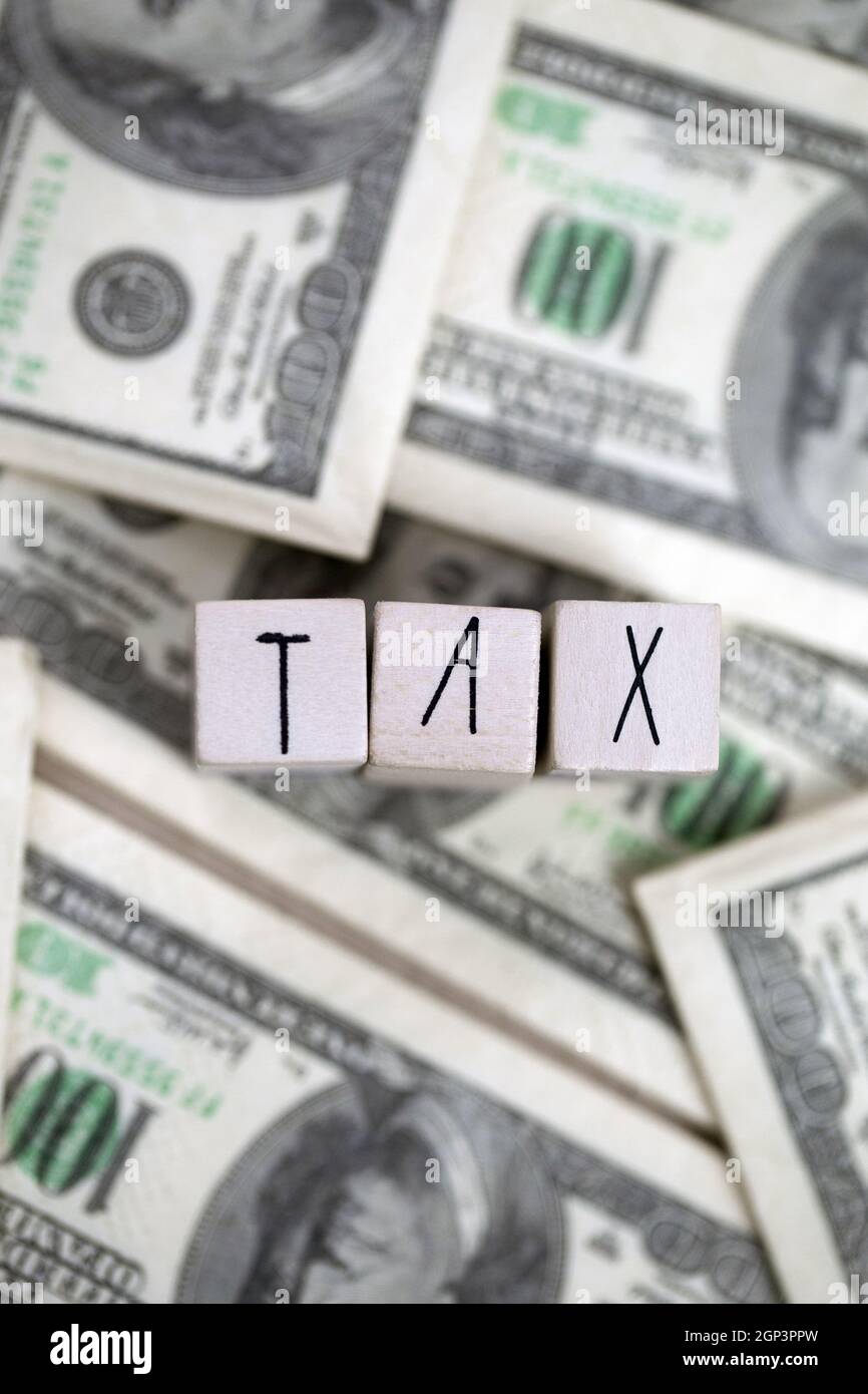 Tax text with hundred dollar bills background, business, financial and ...