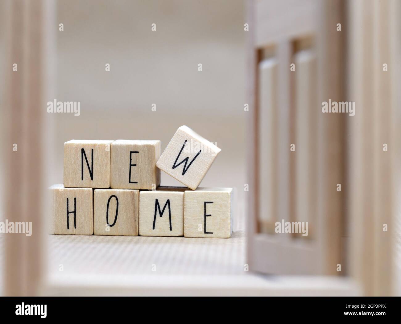 New Home text written with wooden cubes background with symbol of cozy ...